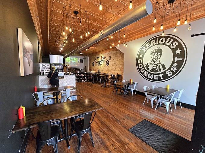 Step inside and the copper-toned tin ceiling, Edison bulbs, and that "Serious Gourmet" mural let you know – these folks aren't playing around with your burger experience.