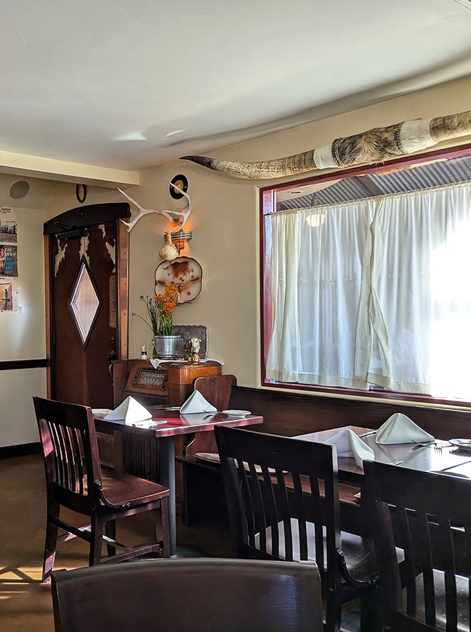 Vintage Western charm meets fine dining inside, where antlers and longhorns create an atmosphere that whispers "something special happens here."