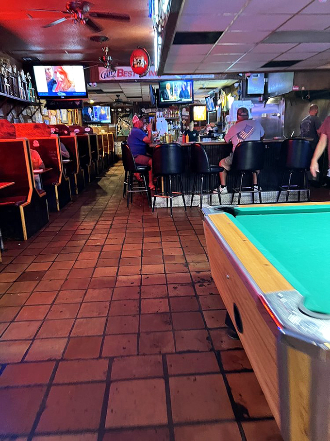 Step inside and time stands still. The classic dive bar interior with terracotta floors, wooden booths, and pool tables creates the perfect backdrop for culinary magic.