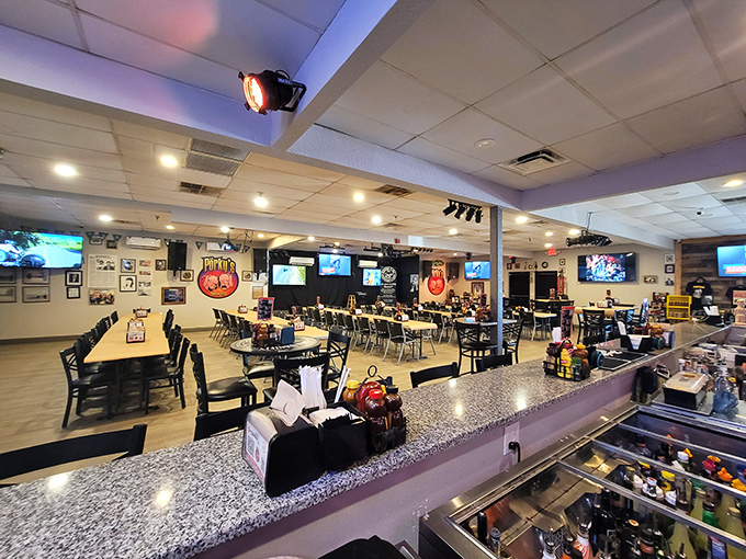 Inside, the spacious dining room balances casual comfort with serious BBQ business. Those TVs aren't the main attraction—your plate will be.