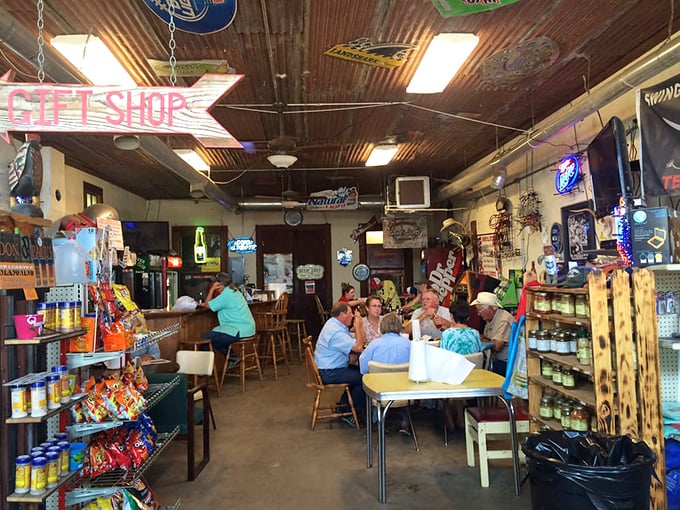 Inside, time stands still as locals gather around mismatched tables beneath a tin ceiling adorned with decades of memorabilia – this is Texas conversation headquarters.