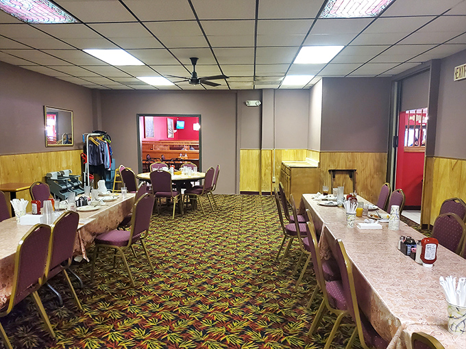 Step inside and time slows down – wood paneling, burgundy chairs, and a carpet pattern that screams "authentic diner experience" in the most comforting way possible.