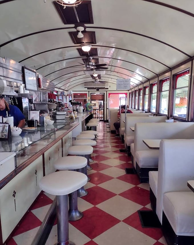 Step inside and time travel begins—the curved ceiling, checkered floor, and row of swivel stools create the quintessential diner experience that Instagram filters try desperately to replicate.