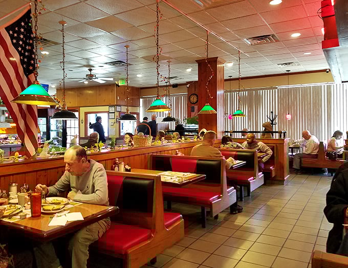 Classic Americana comes alive inside with red vinyl booths, colorful pendant lights, and that unmistakable buzz of satisfied diners plotting their next fork move.