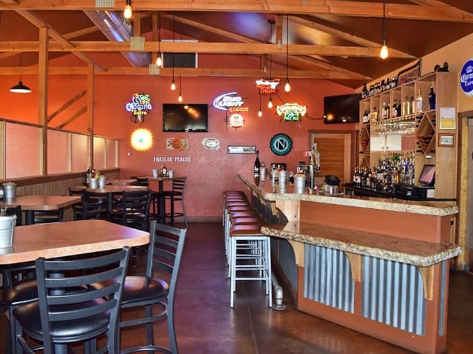 Warm lighting and neon signs create the perfect backdrop for conversations that last until closing time.