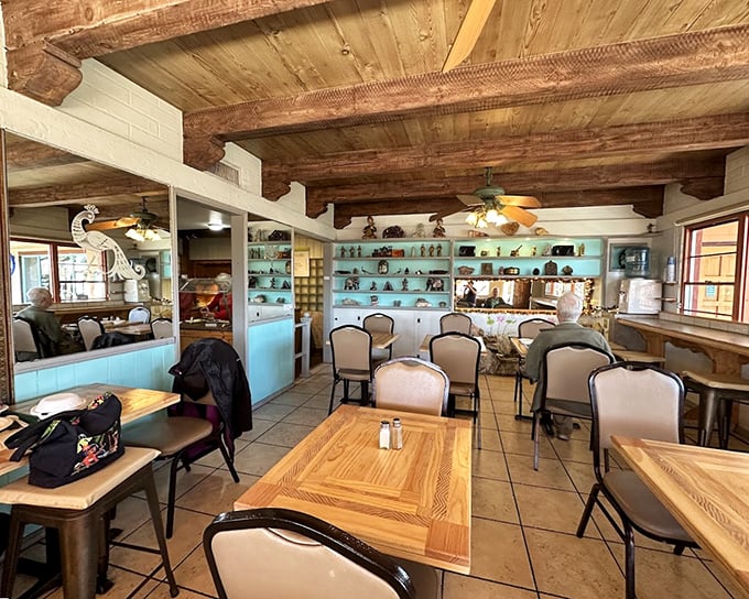 Rustic wooden beams meet turquoise shelving in this dining room that feels like your most interesting friend's living room—if that friend happened to be an exceptional cook.