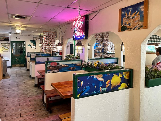 Nautical charm meets desert dining. The neon lobster sign and colorful fish dividers create that perfect "I've discovered something special" atmosphere.