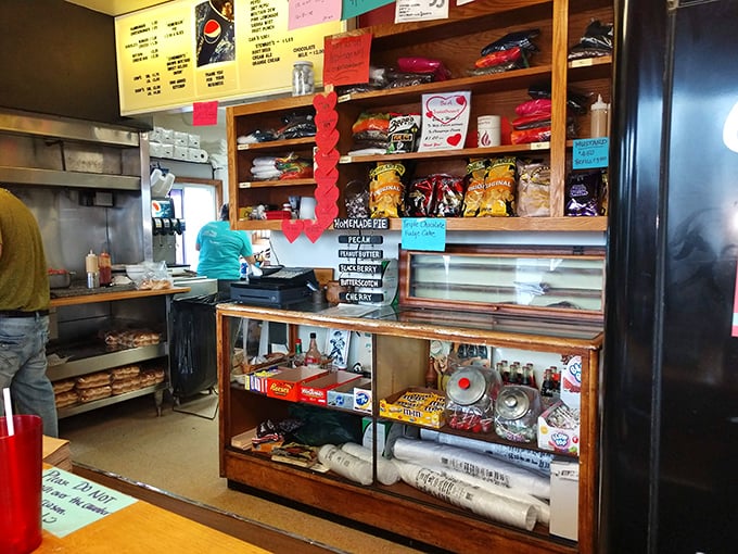 Inside Crabill's, organized chaos reigns supreme—where snacks line the shelves and burger magic happens just feet from hungry patrons.