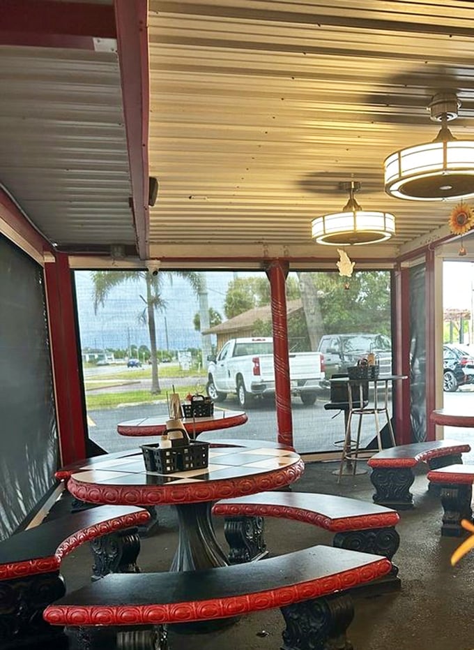 These vintage red-trimmed tables aren't just seating—they're time machines to when conversation was the only thing we scrolled through during dinner.