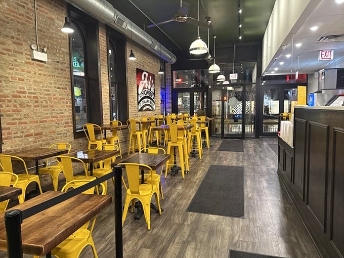 Inside Al's, the exposed brick and sunny yellow chairs aren't just décor choices – they're a visual promise that something gloriously unpretentious and delicious awaits.