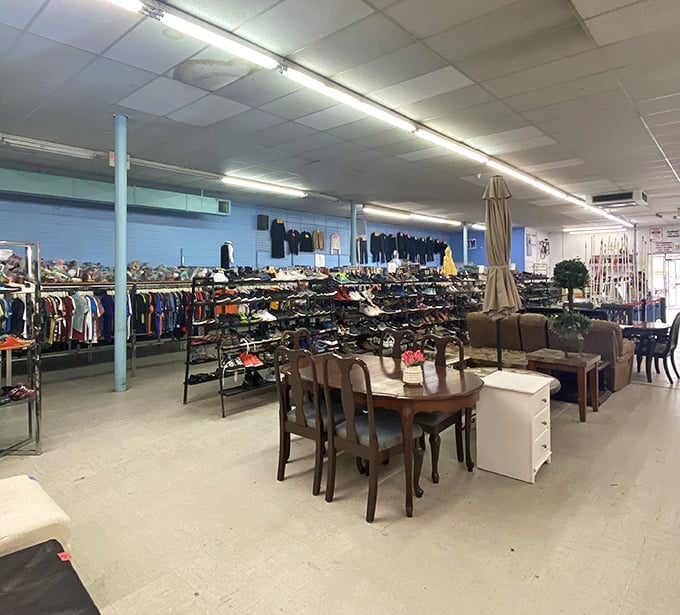 Organized chaos at its finest—racks of clothing stretch toward fluorescent horizons while furniture islands create an archipelago of potential living room makeovers.