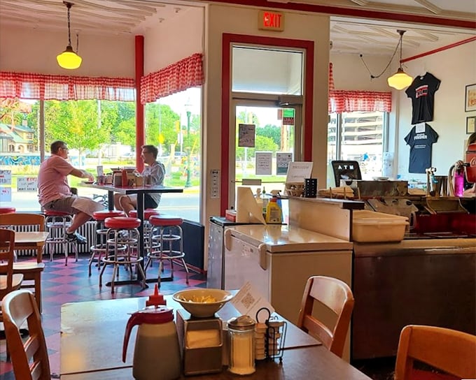 Inside, red gingham curtains and vintage fixtures create the perfect backdrop for conversations that flow as freely as the coffee refills.