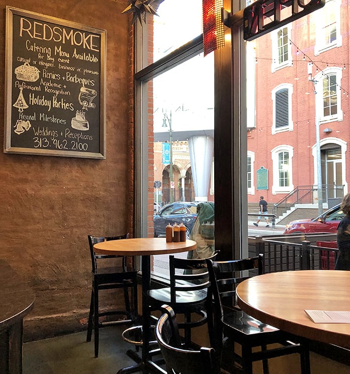 Exposed brick walls, wooden tables, and a chalkboard menu—the barbecue joint trifecta that signals you're about to have a religious experience with smoked meat.