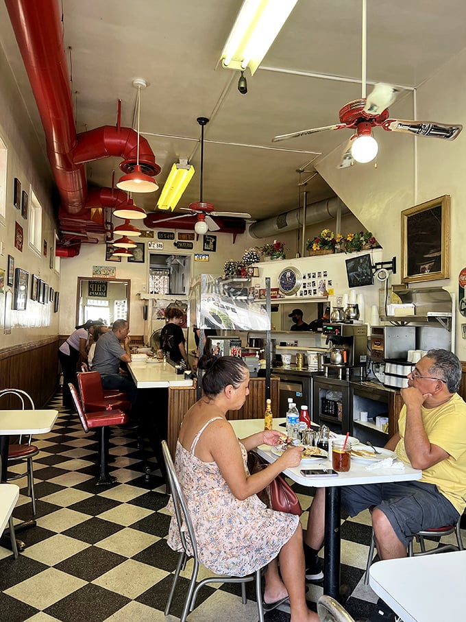 Inside Pop's, the checkerboard floor and red vinyl stools aren't retro by design—they're authentic by survival, creating a time capsule where breakfast dreams come true.