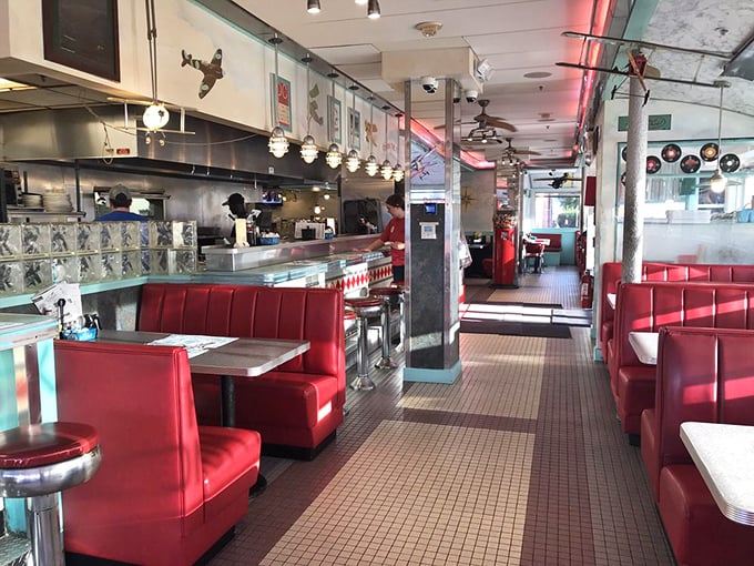 Classic Americana in every detail—cherry-red vinyl booths, gleaming chrome, and that unmistakable diner energy that says "slide in and stay awhile."