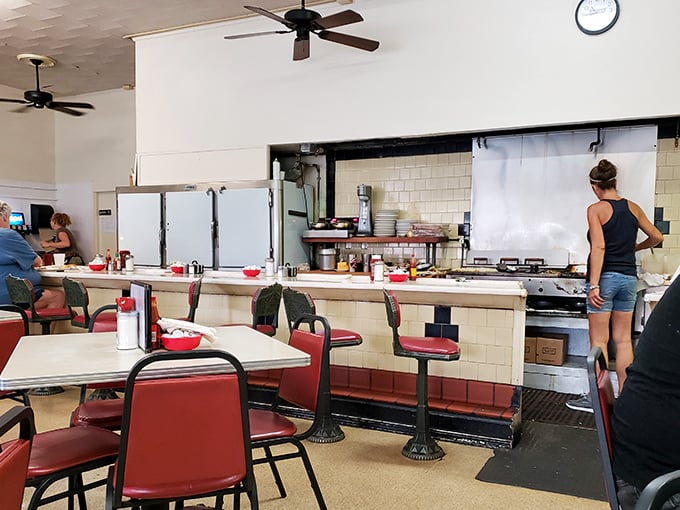 Where breakfast dreams come true – red vinyl stools, ceiling fans spinning lazily overhead, and the sizzle of a well-seasoned grill that's seen more sunrises than most residents.