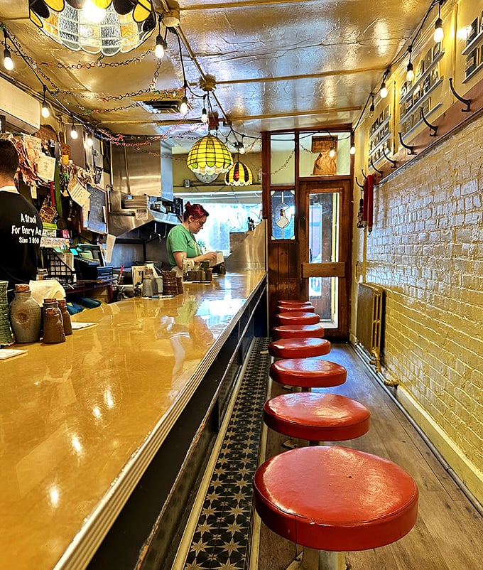 Red stools line the narrow counter where breakfast dreams come true. Al's defies spatial logic—somehow fitting more flavor than square footage.