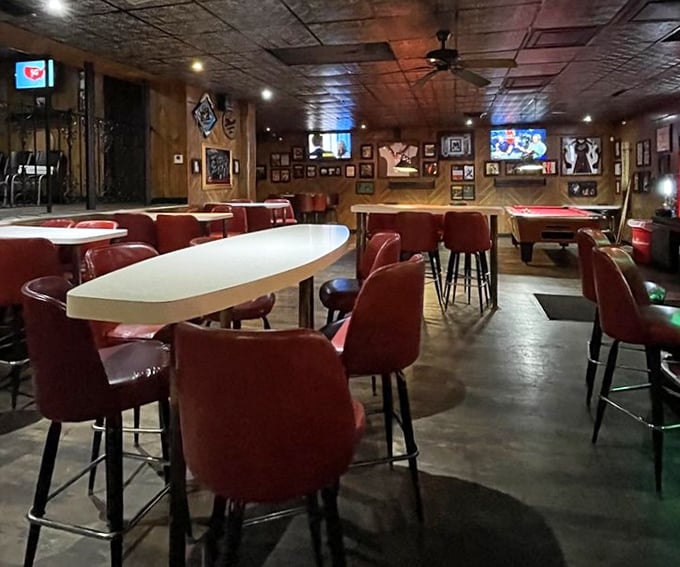 Classic tavern vibes with wood paneling, red chairs, and pool tables in the back – the universal language of "you're among friends here."