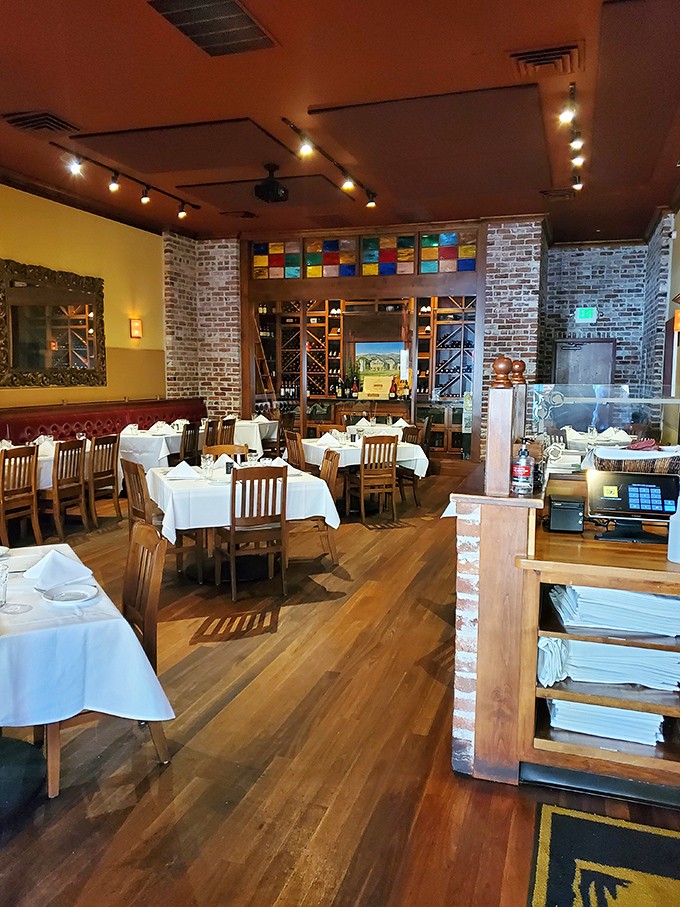 White tablecloths, exposed brick, and that stunning stained glass—this dining room isn't just setting the stage for dinner, it's making a solemn vow to your taste buds.