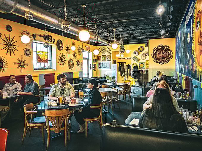Step inside and suddenly you're swimming in sunshine yellow walls adorned with cosmic art—like dining inside a supernova with really good coffee.