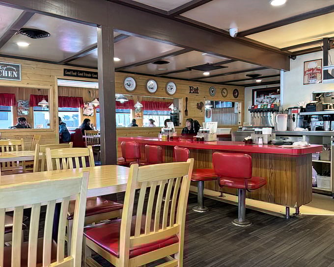 Classic Americana at its finest – red vinyl stools, wooden counters, and that unmistakable diner energy that promises calories well spent.