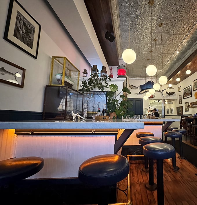 Pressed tin ceilings, globe pendant lights, and nautical touches create that rare atmosphere that's both sophisticated and comfortable—like a fisherman's tale you actually want to hear.