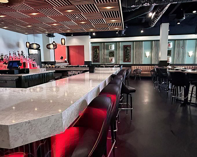 Red accents and wooden lattice ceilings create a dining atmosphere that's both sophisticated and inviting—like a stylish friend's apartment you never want to leave.