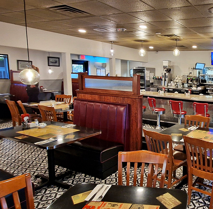 Classic red vinyl booths and wooden chairs create that perfect diner atmosphere—where calories don't count and coffee refills are practically mandatory.