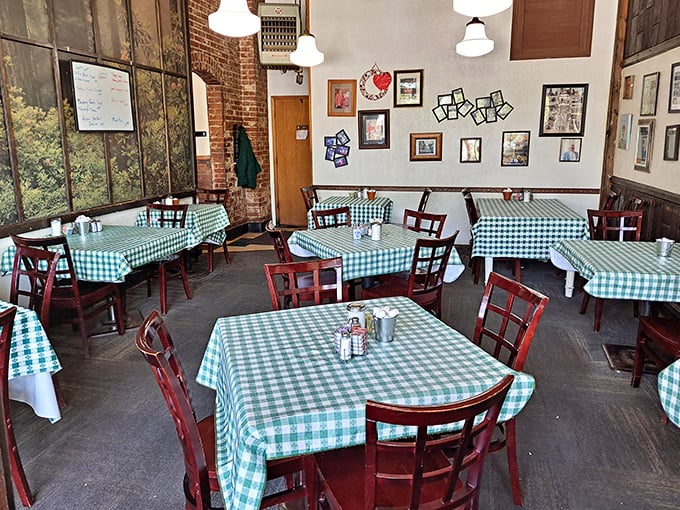 Green checkered tablecloths and wooden chairs create that perfect "grandma's kitchen" vibe where comfort food memories are made daily.