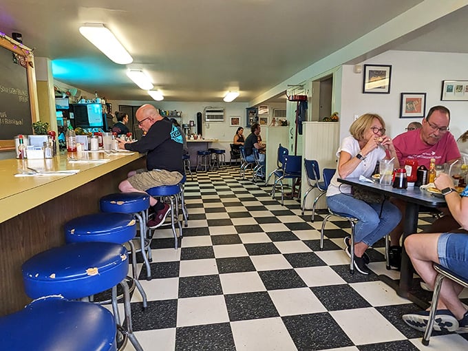 The classic black and white checkered floor isn't just nostalgic—it's practically the universal signal for "good food happens here."