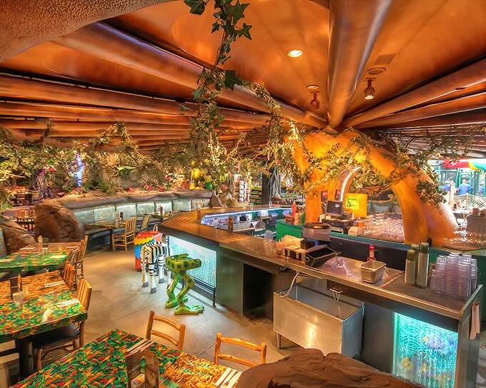 Dining under a canopy of artificial foliage and mood lighting creates an atmosphere that's equal parts Jurassic Park and upscale treehouse.