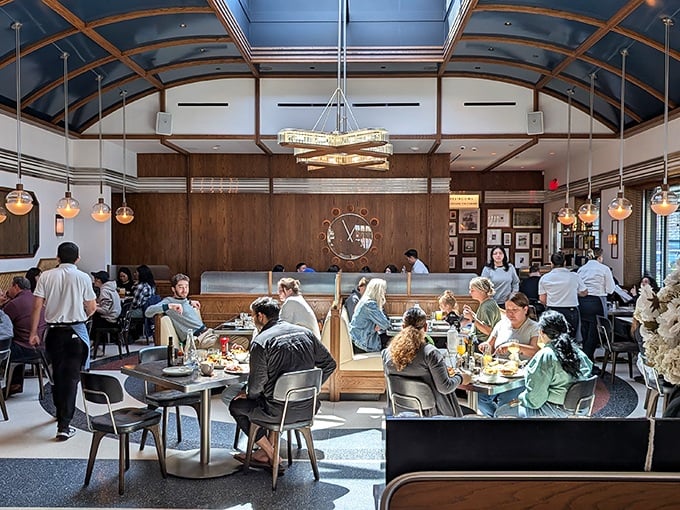 Inside, soaring ceilings and warm wood paneling create an atmosphere that's both grand and cozy—like dining in your dream kitchen, if your dreams had impeccable taste. 