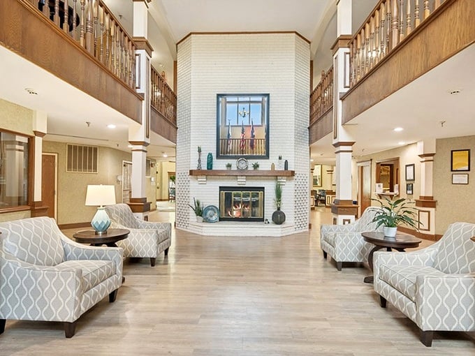 
A fireplace that would make HGTV hosts weep with joy anchors this grand lobby, where comfort meets elegance without a hint of institutional vibes. 
