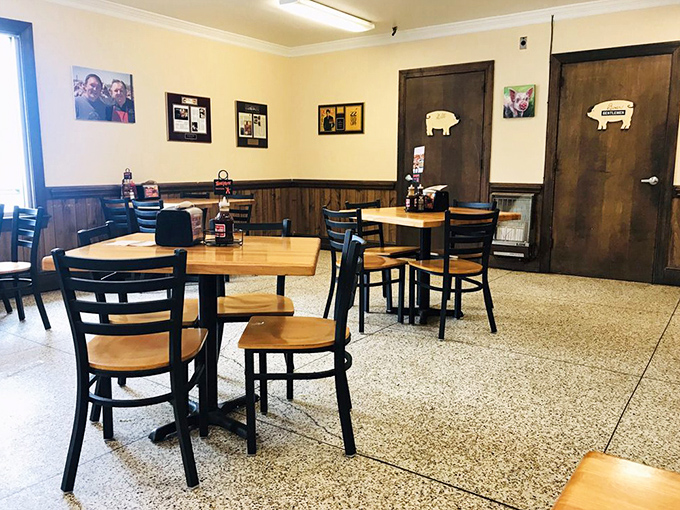 No white tablecloths here—just honest wood paneling, simple tables, and walls that tell the story of barbecue pilgrims who came before you.