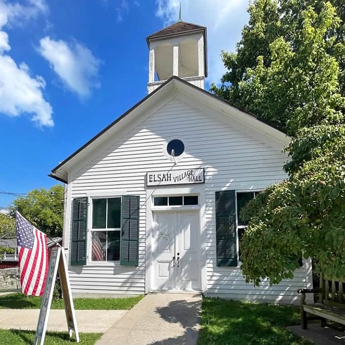 Small-town democracy in action. The Elsah Village Hall stands as a pristine white sentinel, its modest bell tower a reminder of simpler civic times.