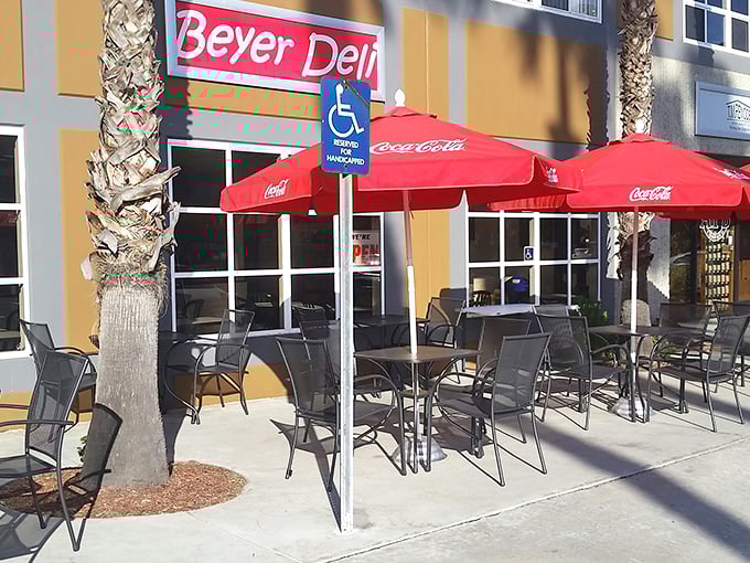 Beyer Deli's outdoor seating area – where sandwiches taste even better under those cheerful red umbrellas and California sunshine.