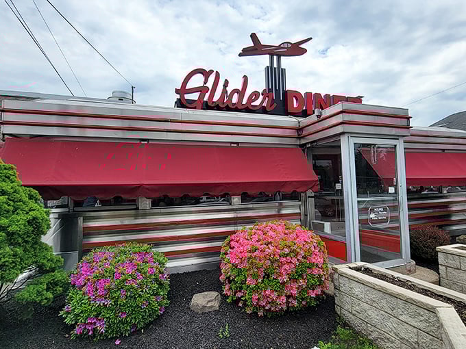 That airplane sign isn't just for show—this place's comfort food will have your taste buds soaring. Pink azaleas add a perfect pop of color.