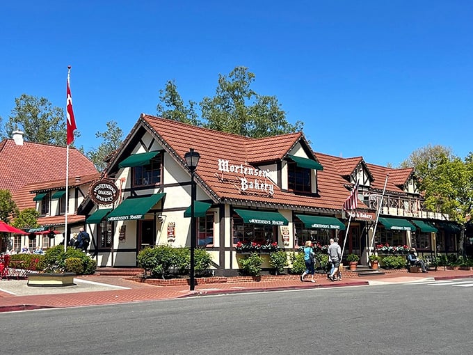 Green awnings and Tudor charm make this corner feel like Copenhagen decided to vacation permanently.