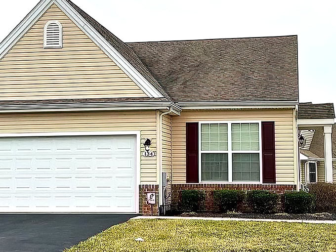 This Spring Meadow residence showcases classic brick accents and shutters—retirement living with curb appeal that would make HGTV proud.