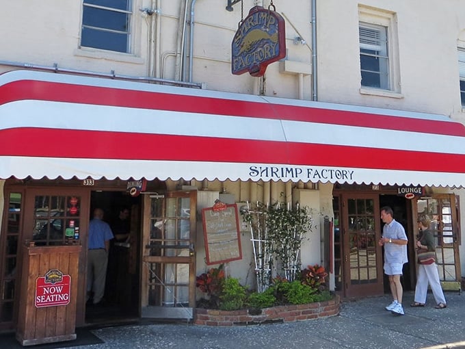 The Shrimp Factory's iconic red and white awning on River Street – like a lighthouse guiding hungry souls to seafood salvation.