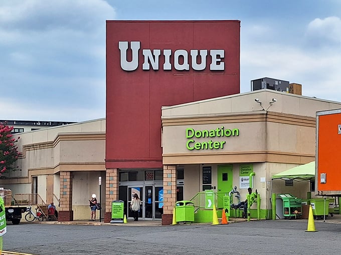 Unique's bold red signage and green donation center create a colorful gateway to secondhand paradise. Thrifting doesn't get more inviting than this!