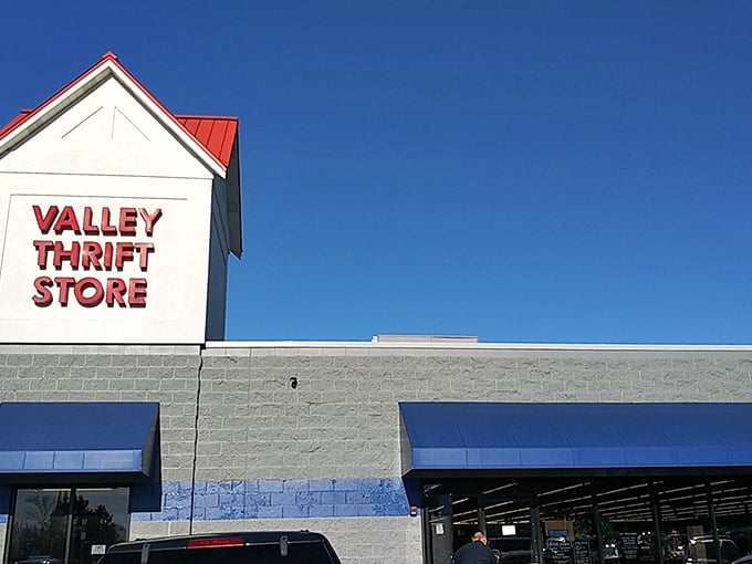 Valley Thrift's bold red sign against clear blue skies – a beacon of hope for your wallet and your home decorating dreams.