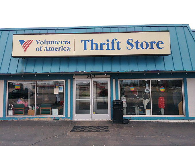This blue-striped storefront proves that the best treasures often hide in the most unexpected places.