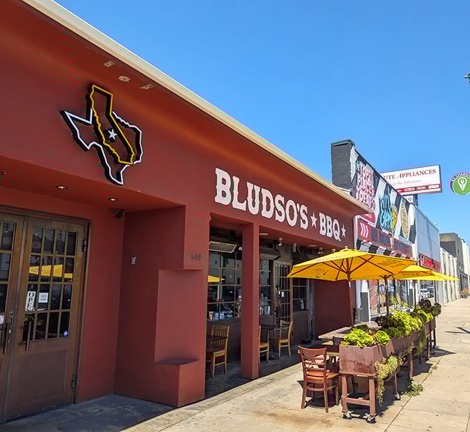 The bold Texas silhouette on Bludso's brick-red facade is no empty promise—this is legitimate Lone Star smoke in the heart of Hollywood.