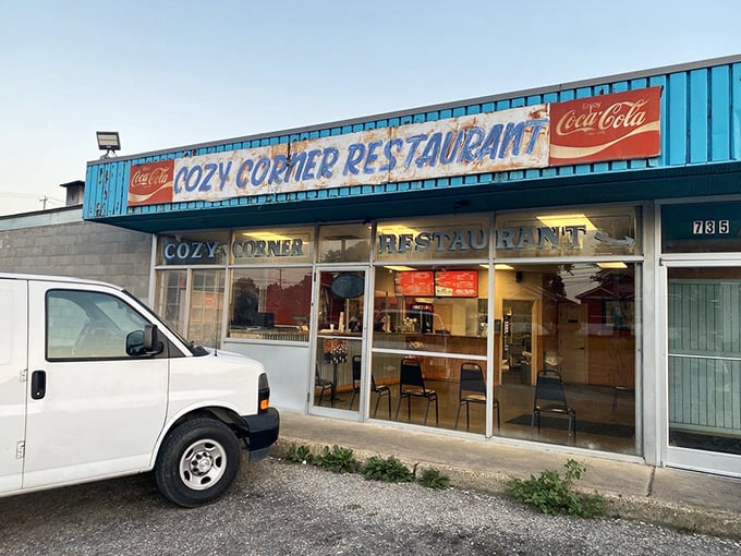 The neon "OPEN" sign might as well say "HEAVEN" - Cozy Corner's no-frills exterior hides chicken worth crossing roads for.