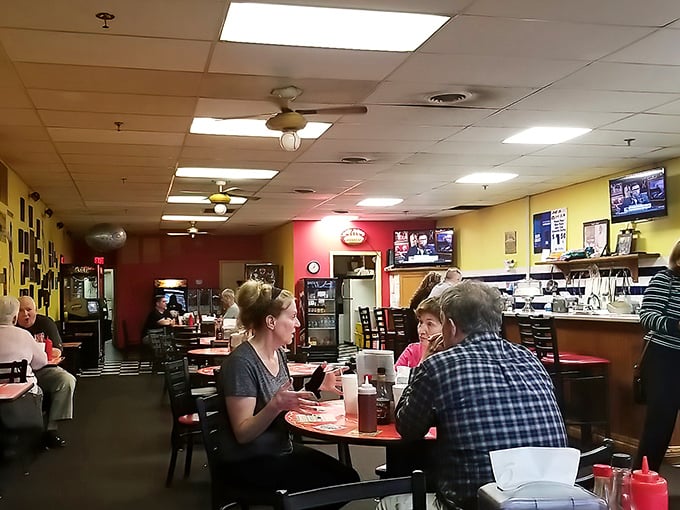 That cozy dining room says "stay awhile" while the menu board whispers sweet, saucy promises to your taste buds.