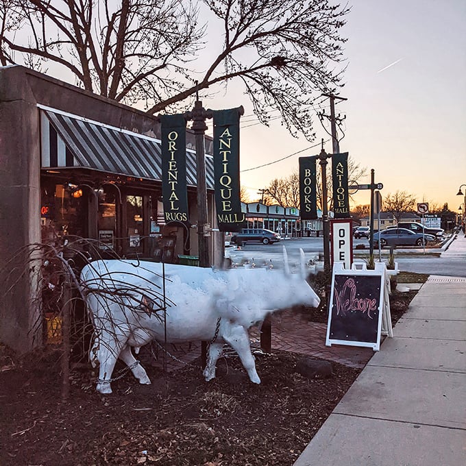 Dusk settles over the antique mall's entrance, where that white decorative cow seems to say, "Come browse awhile!"