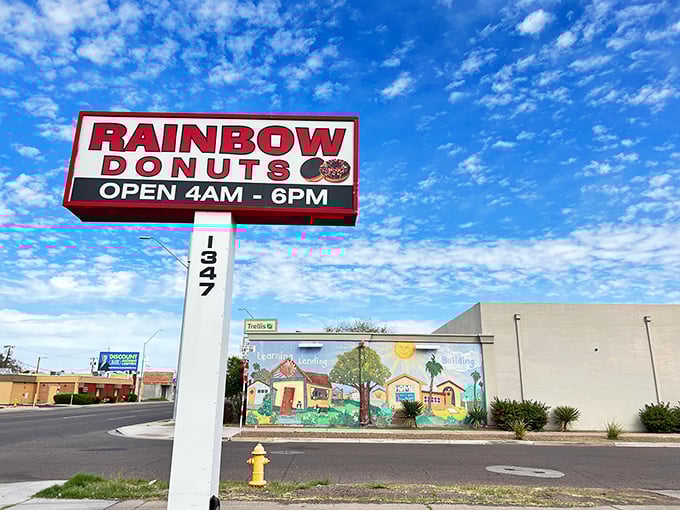 The classic donut shop sign stands tall like a beacon for sugar seekers everywhere. 