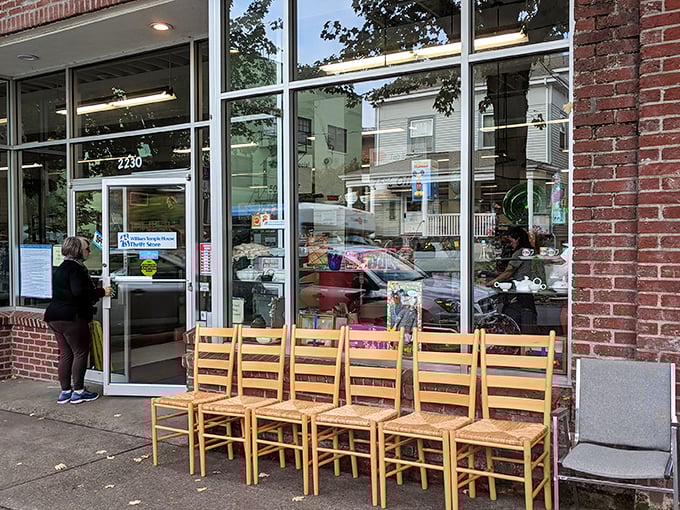 Those wooden chairs lined up outside are like a welcoming committee for the vintage gems hiding inside.