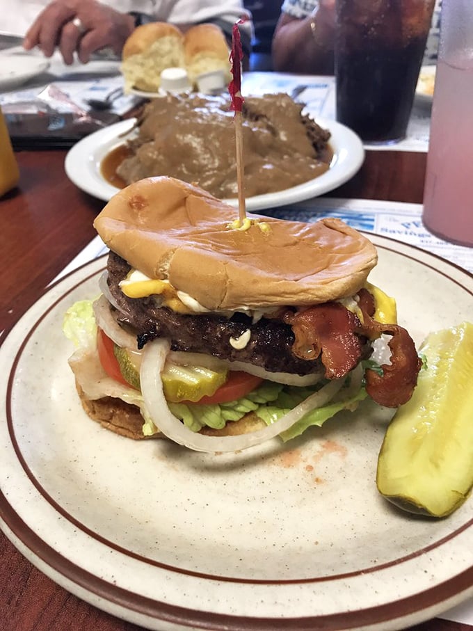 The legendary bison burger in all its glory – a towering masterpiece that makes regular burgers look like they're not even trying.